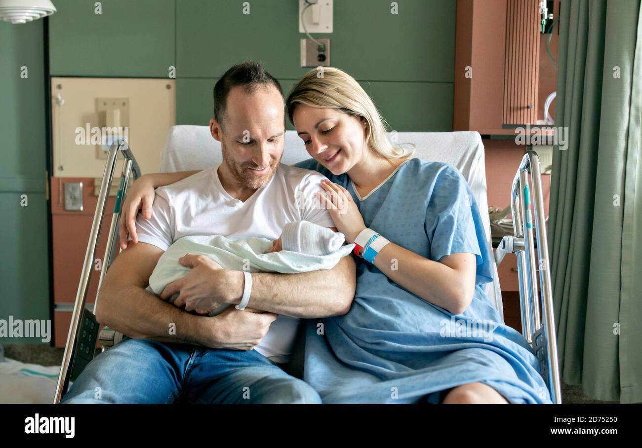 Mother and father with her newborn baby at the hospital a day after a ...
