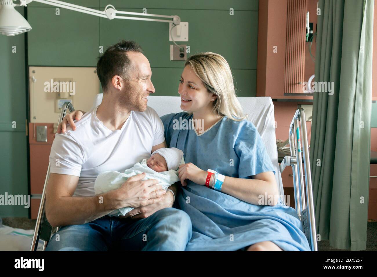 Mother and father with her newborn baby at the hospital a day after a ...