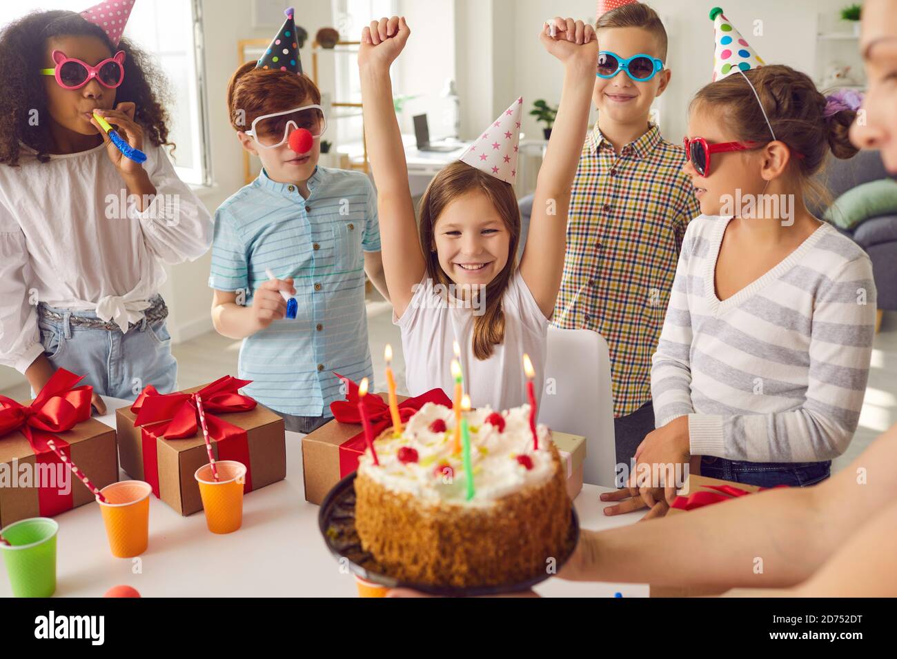 Bunch of happy children celebrating their friend's birthday at fun ...