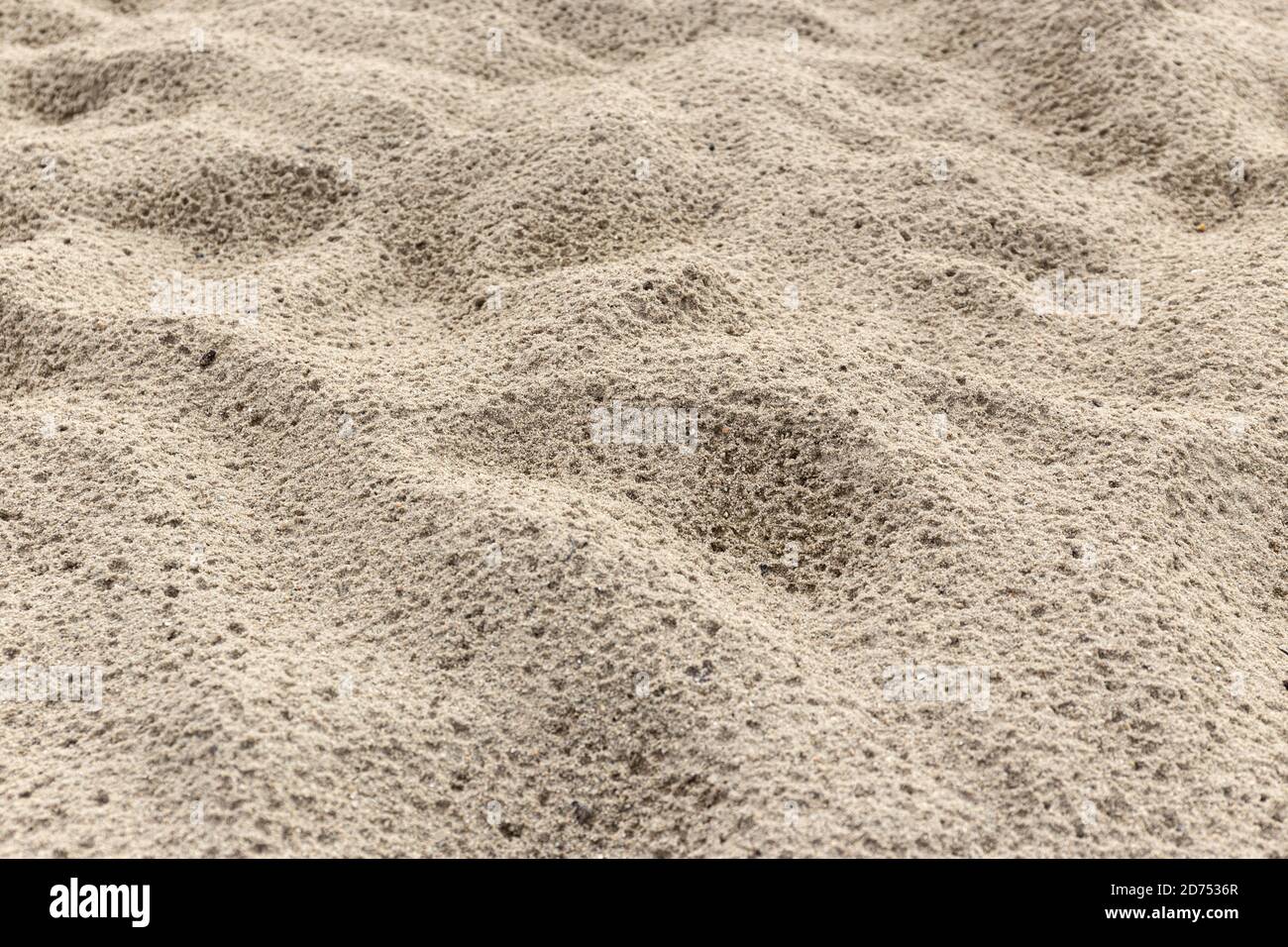 Sand background texture after rain. Wet Sandy beach Stock Photo - Alamy