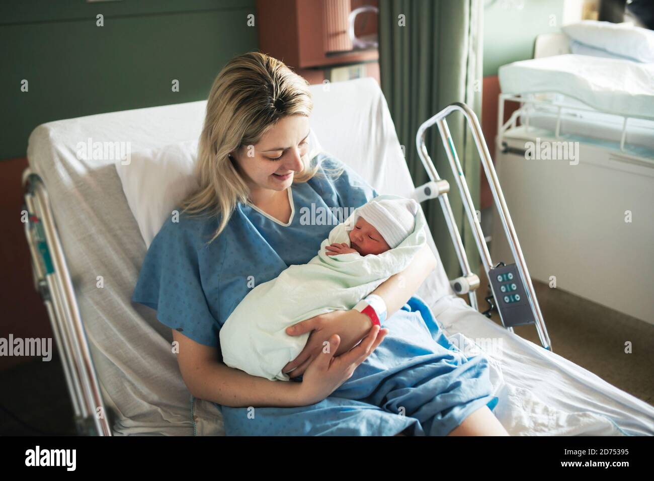 Mother with her newborn baby at the hospital a day after a natural ...