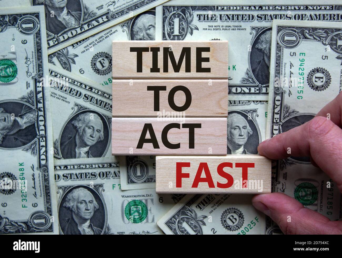 Male hand placing a block with word 'fast' on a blocks tower with words ...