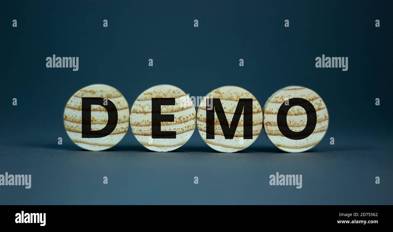 Wooden small circles with letters 'demo' on a beautiful grey background ...