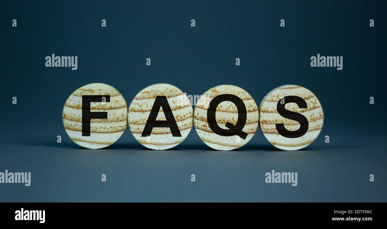 Concept word 'FAQS' on wooden circles on a beautiful grey background ...
