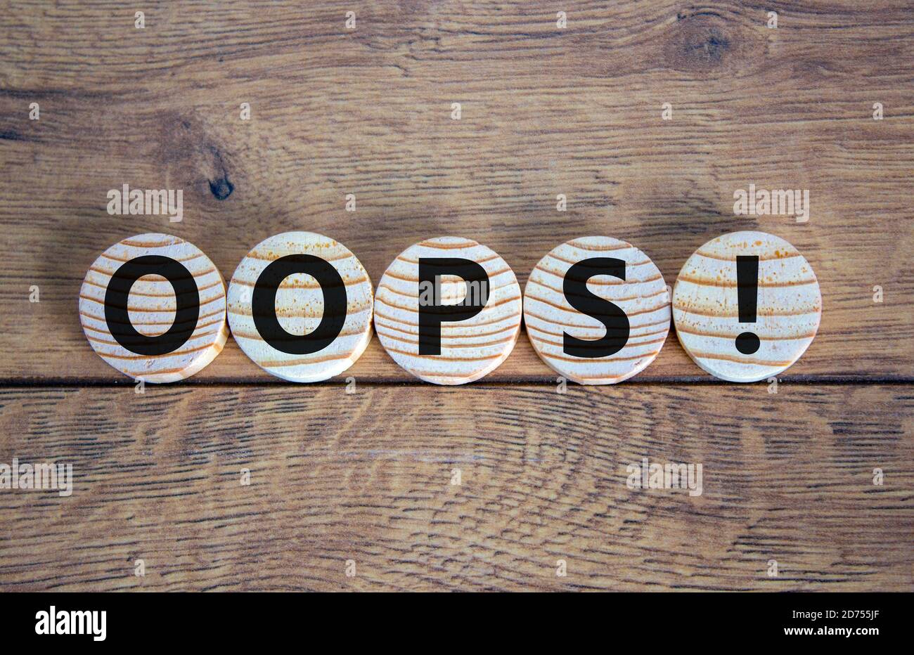 Oops sign on wooden circles. Beautiful wooden background, copy space ...