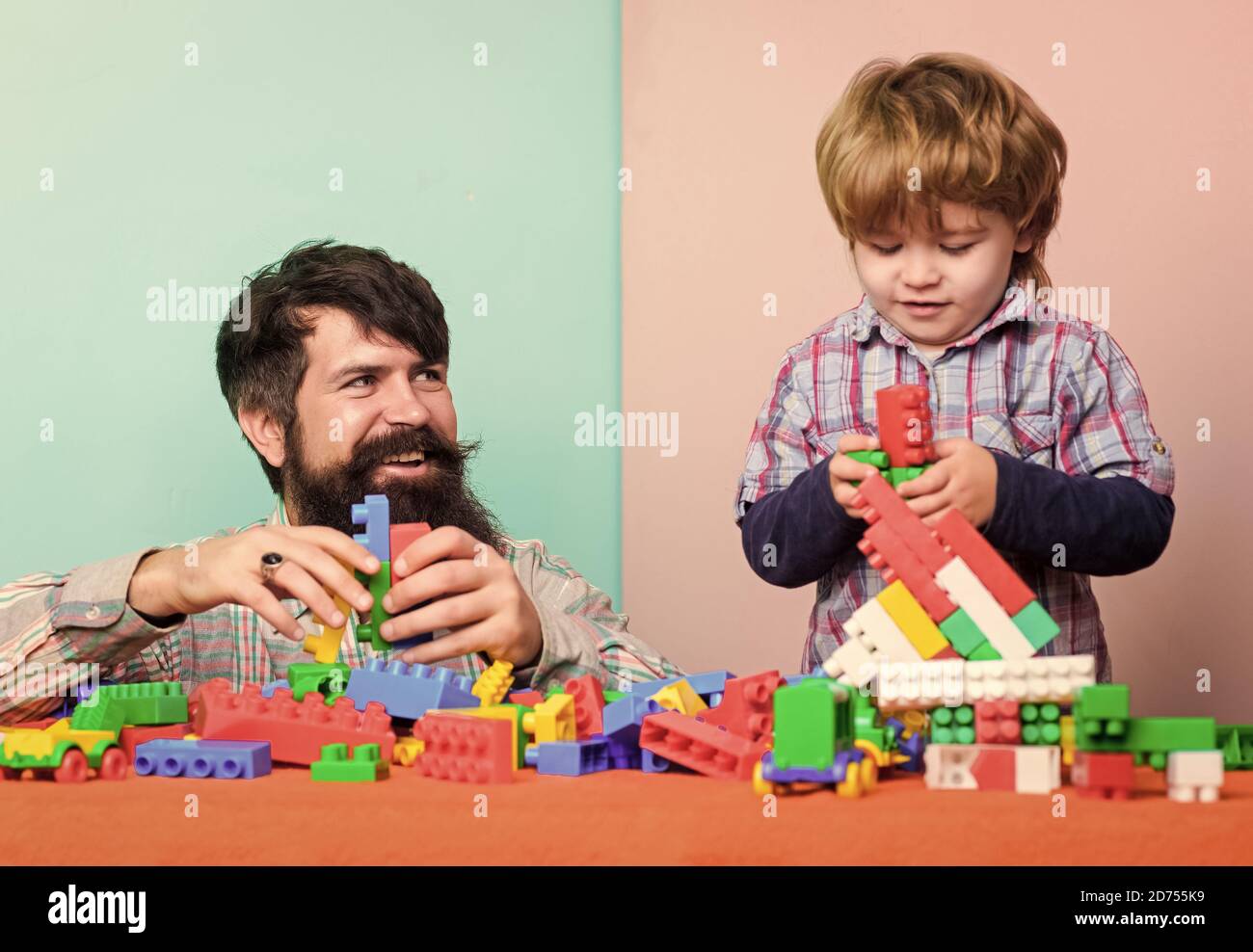 Father son game. Father and son create colorful constructions with ...