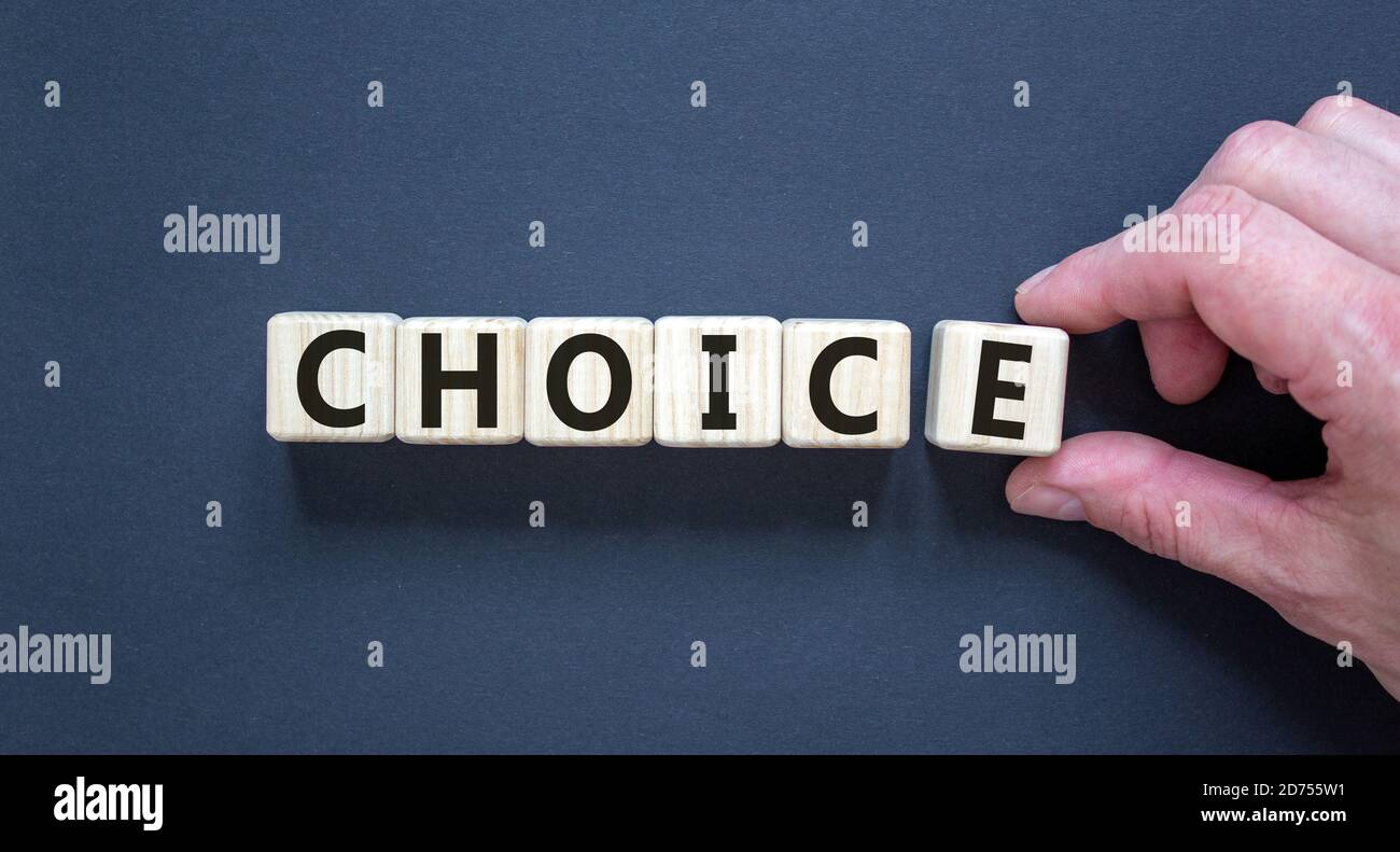 CHOICE word written on wood block. Male hand. CHOICE text on dark ...