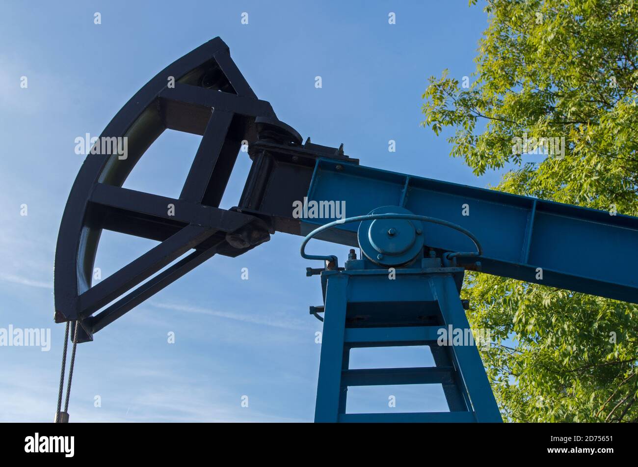 Industrial block pumping unit with blue framed body and black rocking ...