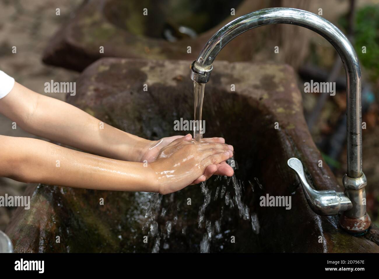Hygiene concept cleaning hand and washing hands in the public park. A ...