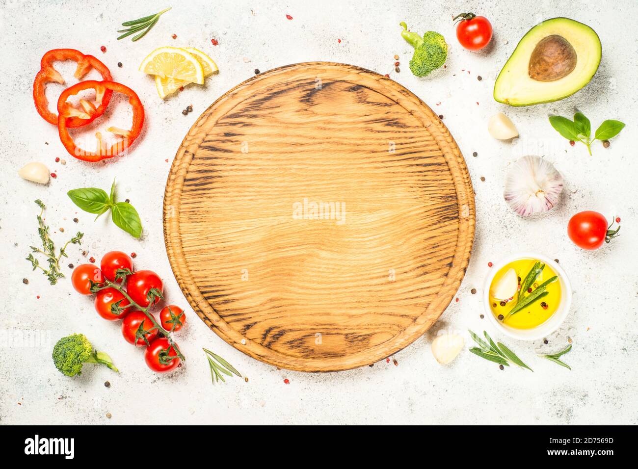 Herbs, spices and vegetables at white kitchen table Stock Photo - Alamy