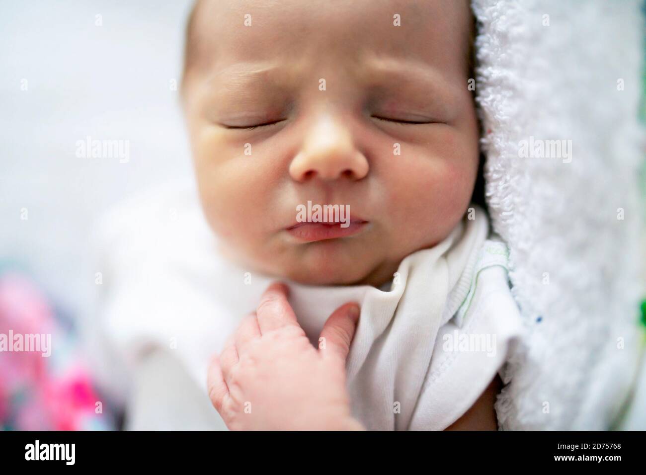 A Sweet newborn baby girl sleeping in white bed Stock Photo - Alamy