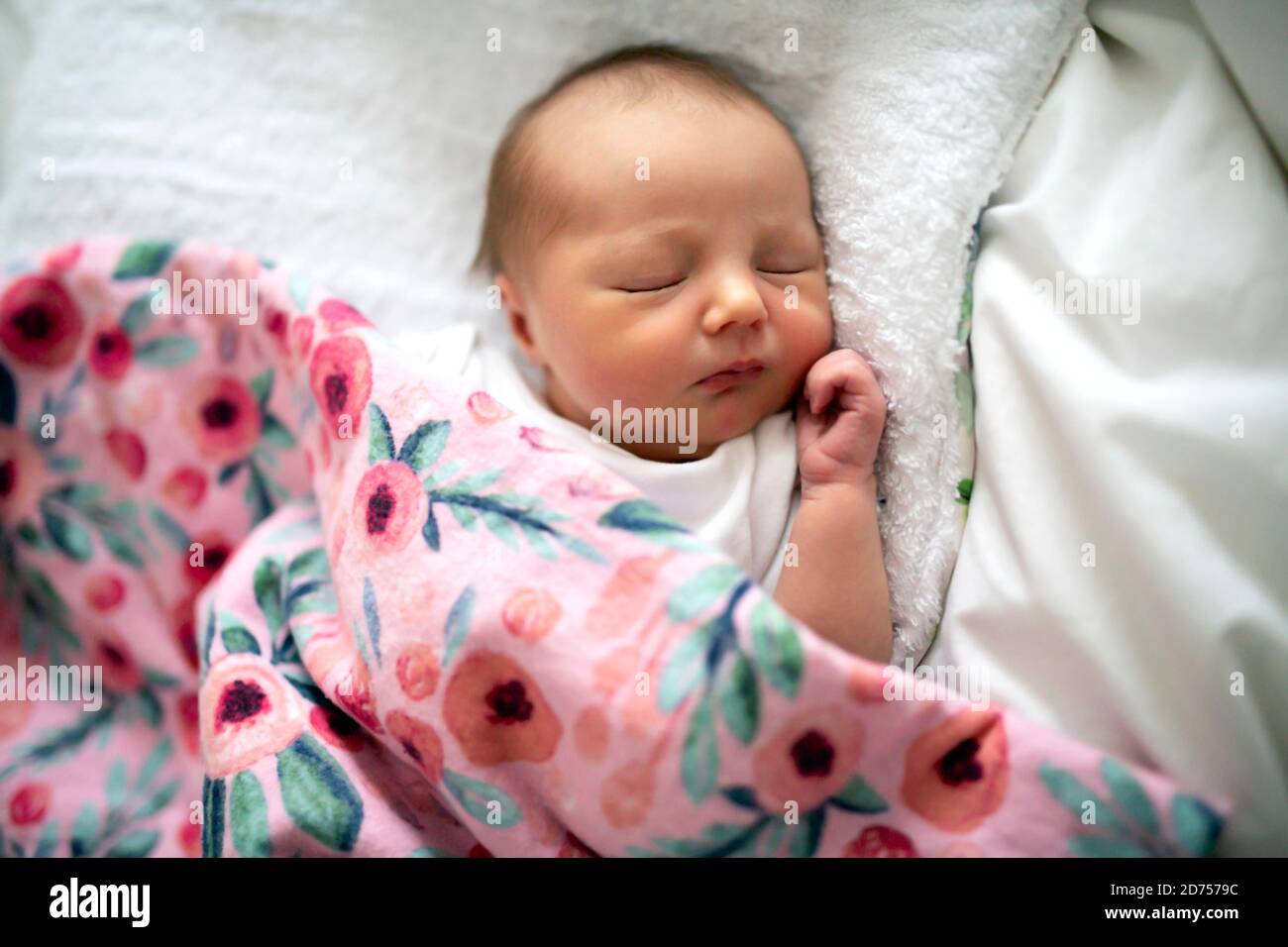 A Sweet newborn baby girl sleeping in white bed Stock Photo - Alamy