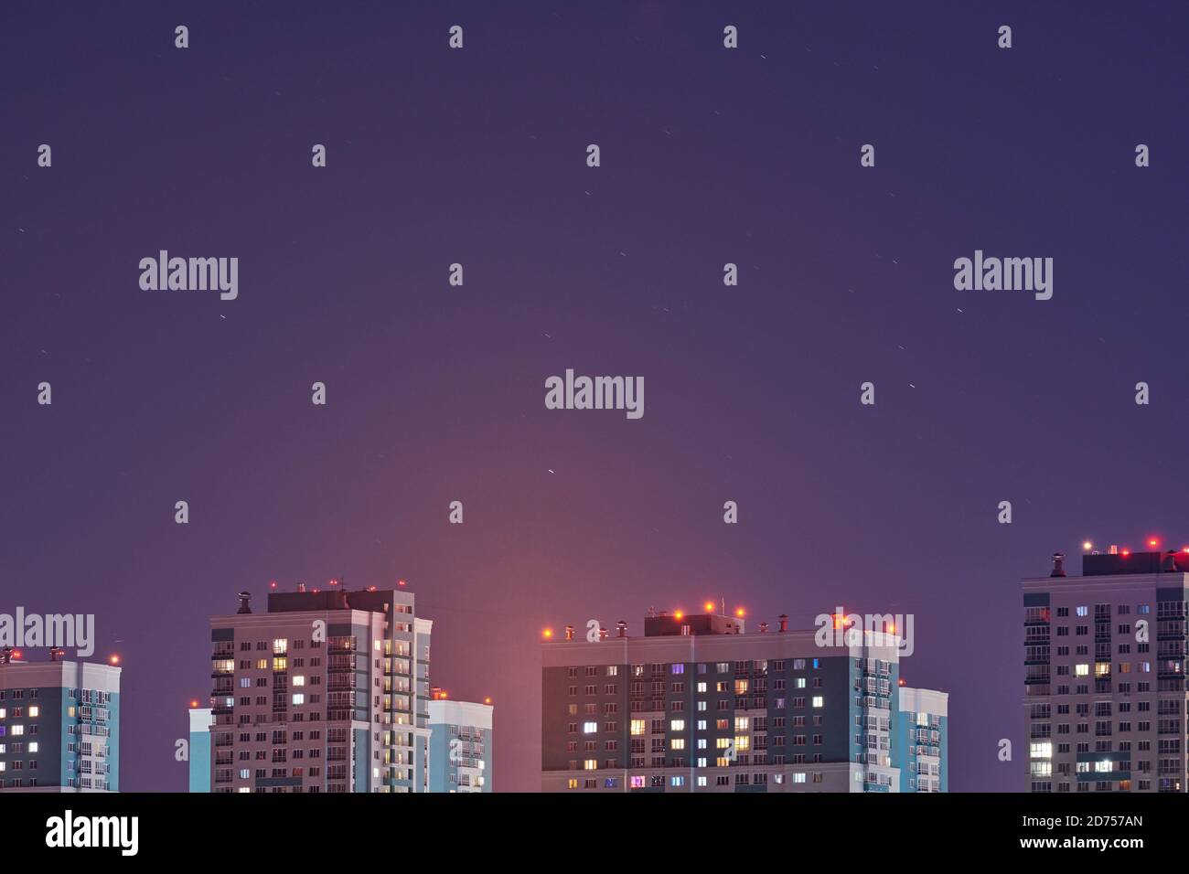 Multistorey buildings at night lights, copy space. Long exposure ...