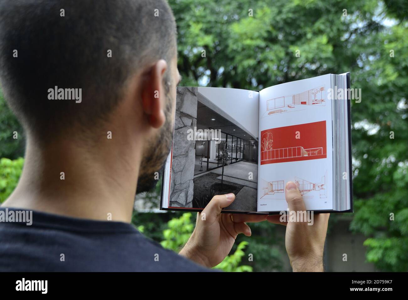 Man reading 'Case Study Houses' book Stock Photo - Alamy