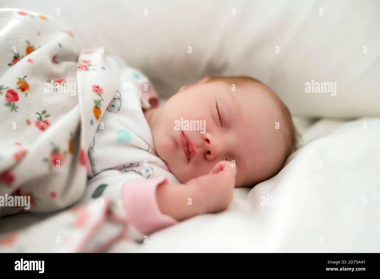A Sweet newborn baby girl sleeping in white bed Stock Photo - Alamy