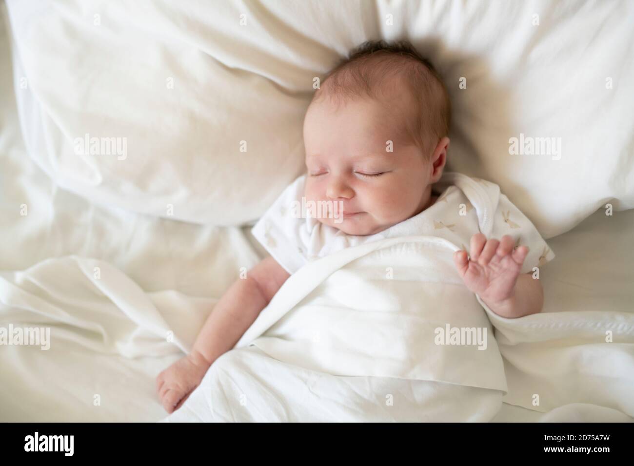 A Sweet newborn baby girl sleeping in white bed Stock Photo - Alamy