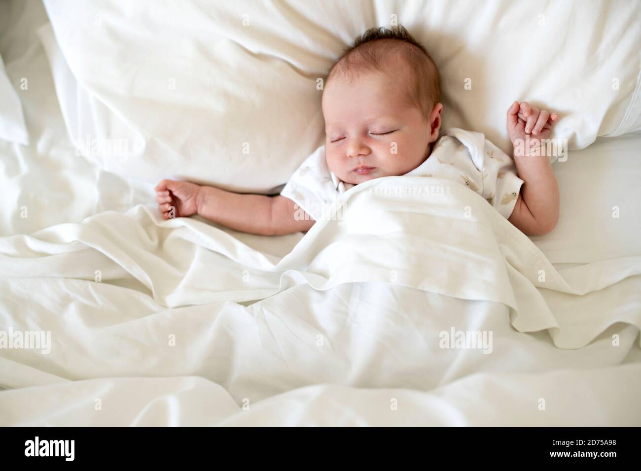 A Sweet newborn baby girl sleeping in white bed Stock Photo - Alamy