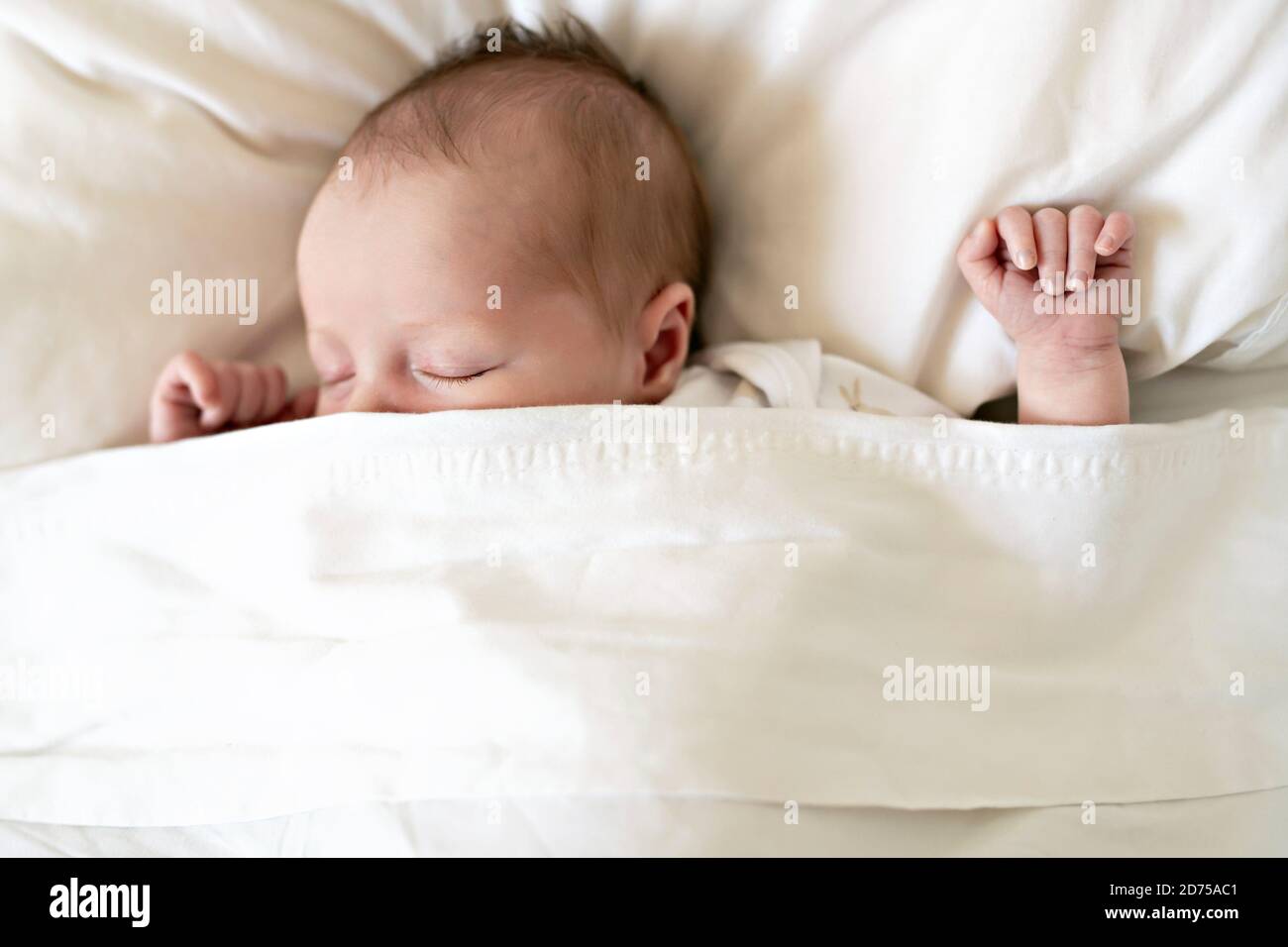 A Sweet newborn baby girl sleeping in white bed Stock Photo - Alamy
