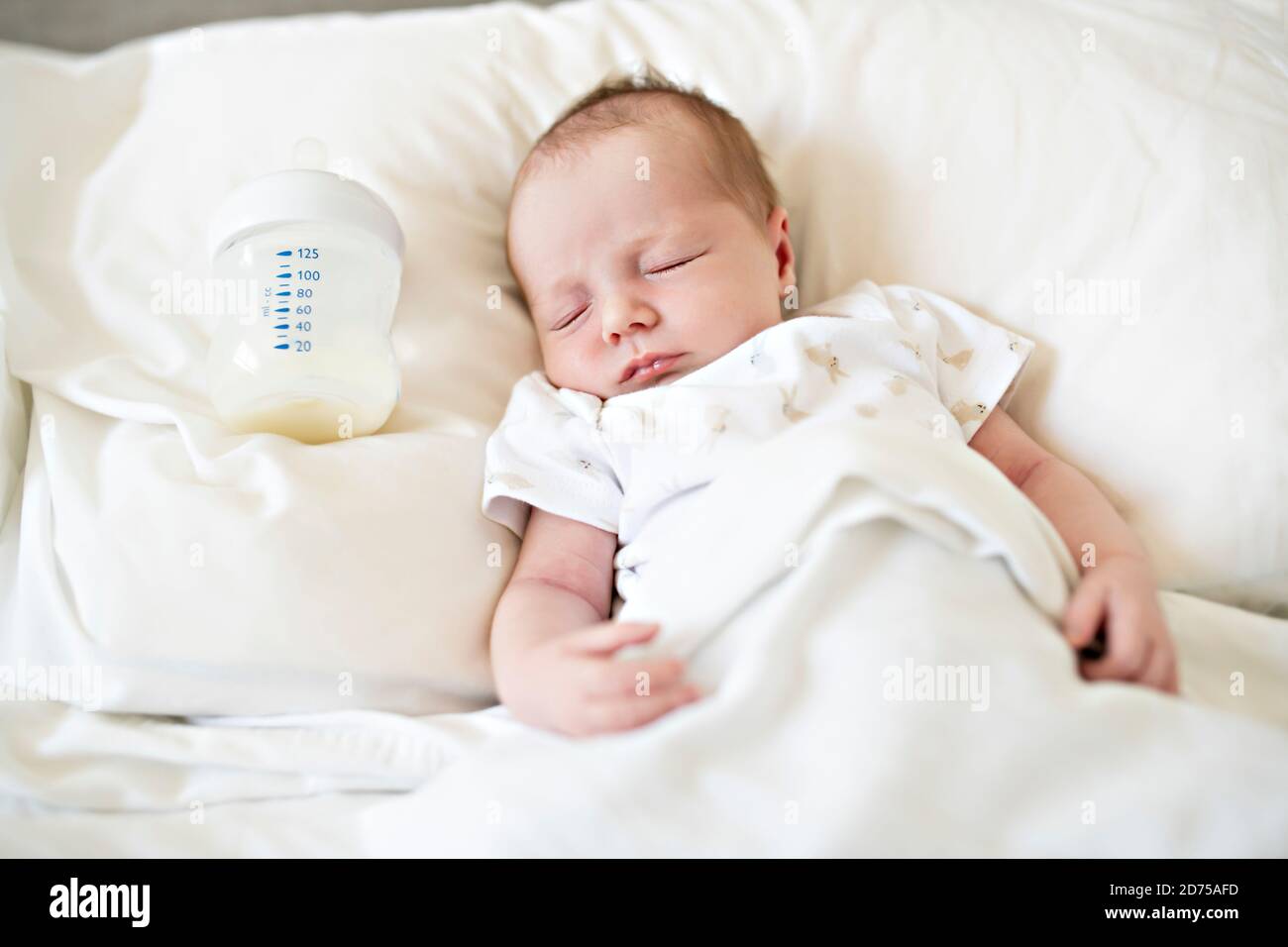 A Sweet newborn baby girl sleeping in white bed Stock Photo - Alamy
