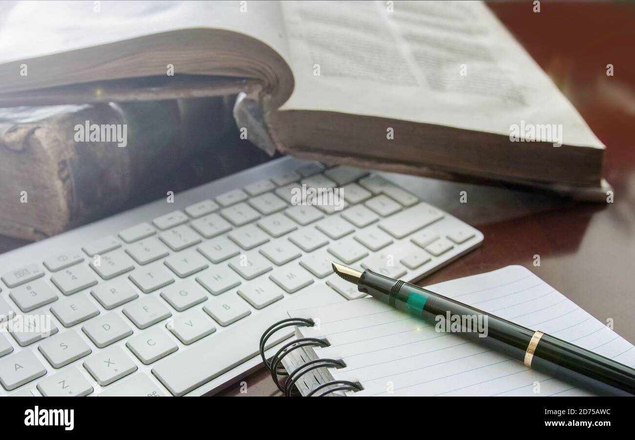 Ancient book, computer k-board, fountain pen and notes book Stock Photo ...