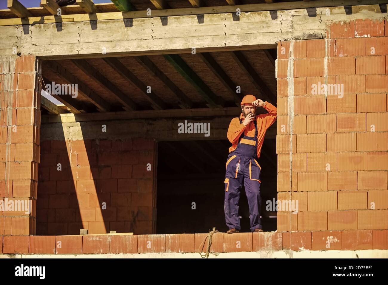 repairman engineer wear helmet on site. tired builder relax ...