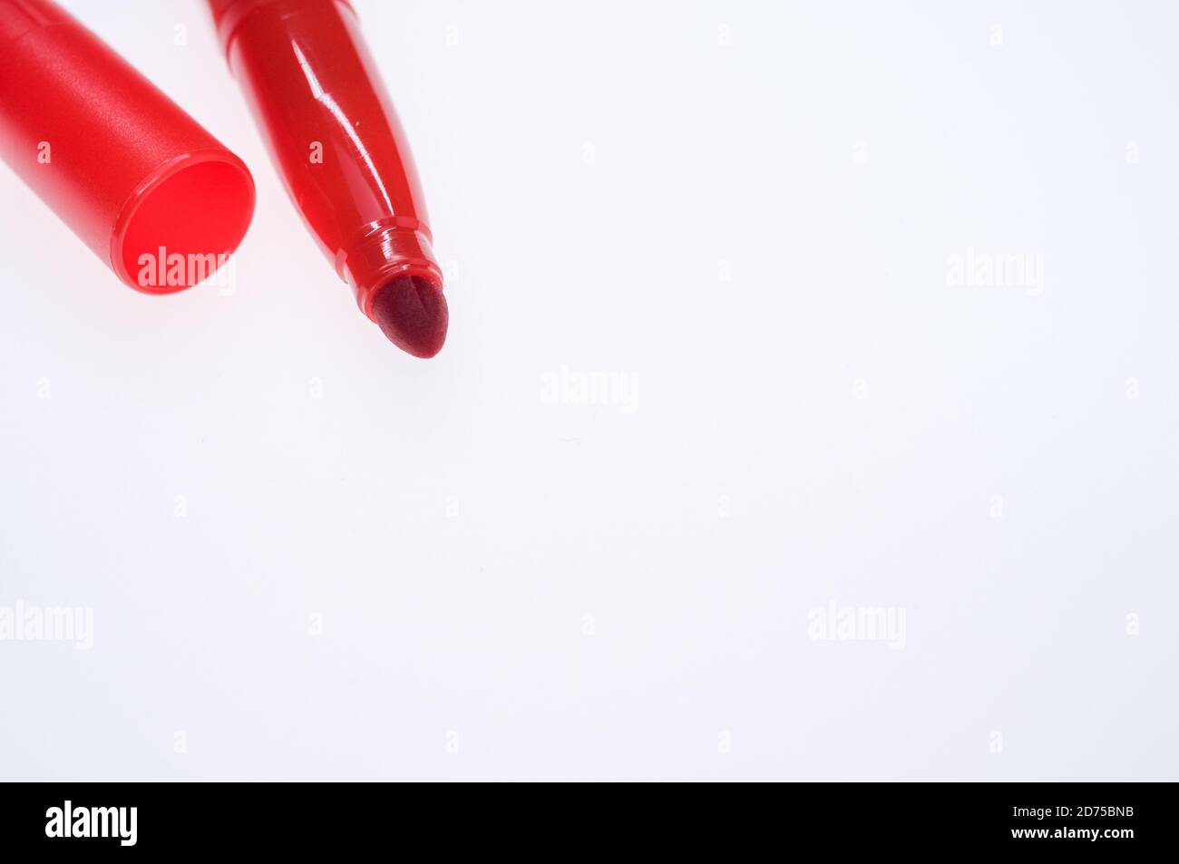 Closeup of a red marker with the cap off isolated on a white background ...