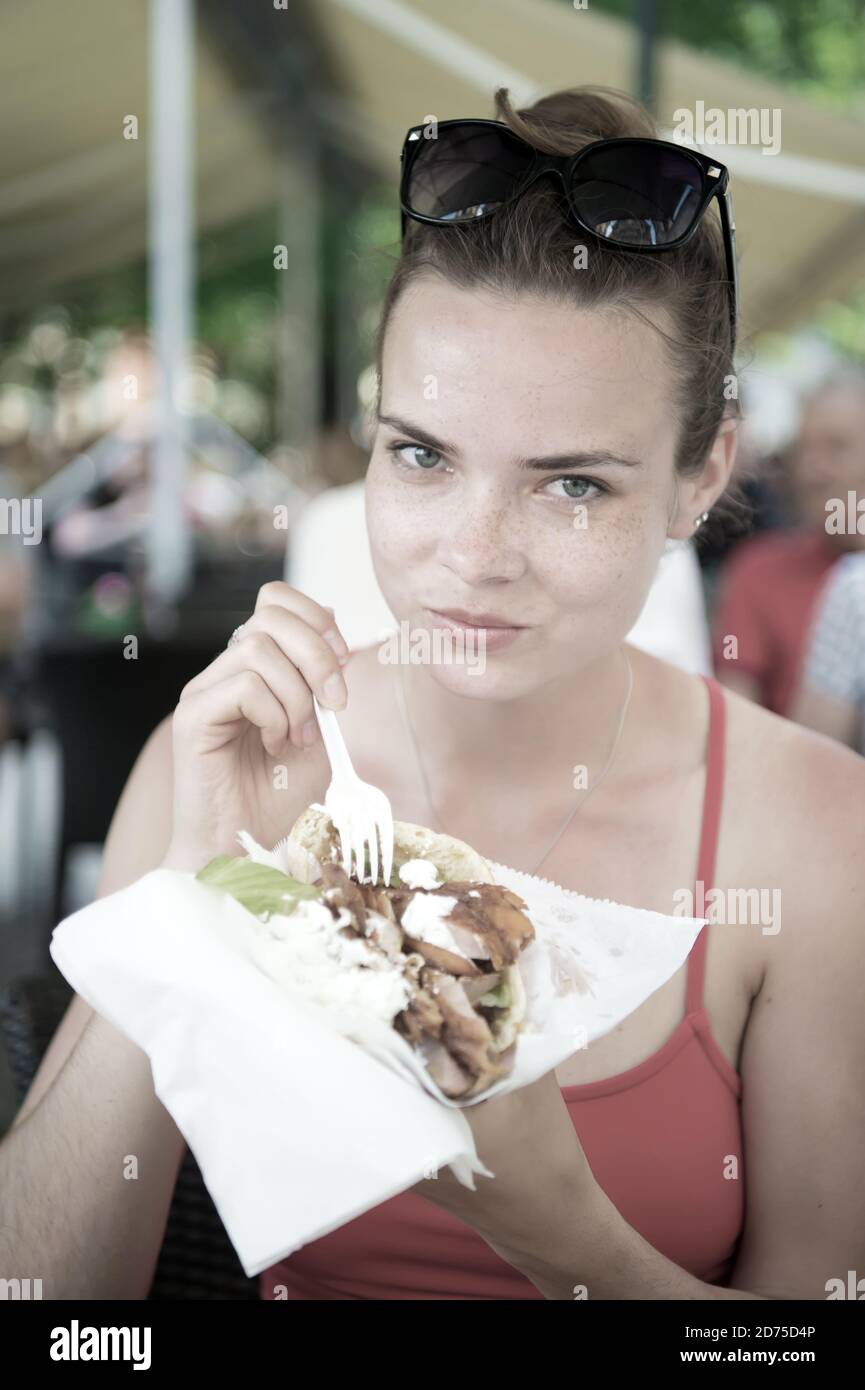 pretty girl or Woman eating sandwich gyros. Girl with pleasure eats ...