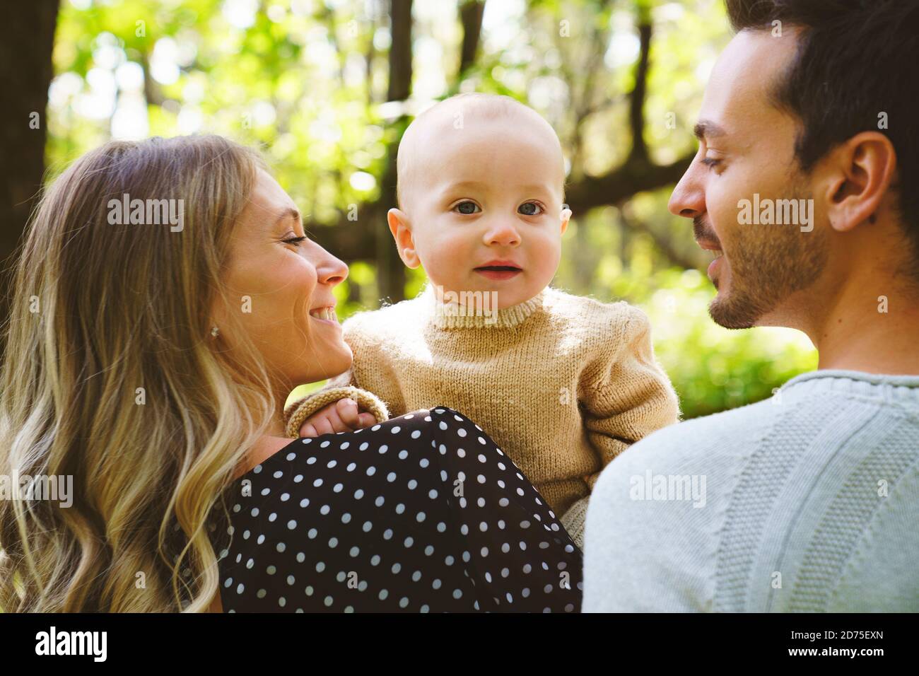 Family with a baby having fun in the forest Stock Photo - Alamy