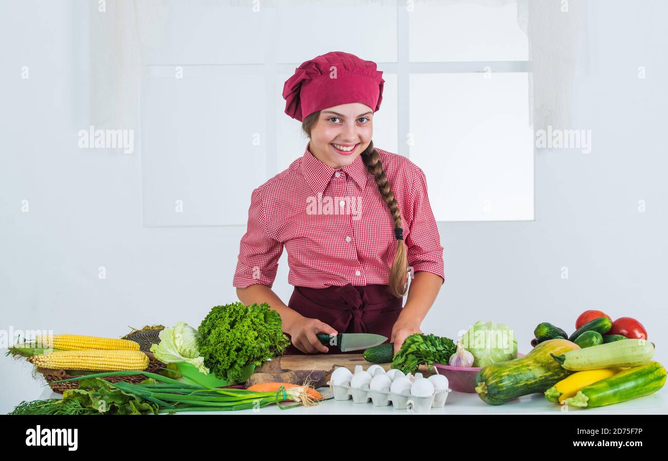 my favorite hobby. kid wear chef uniform and hat. teen girl preparing ...