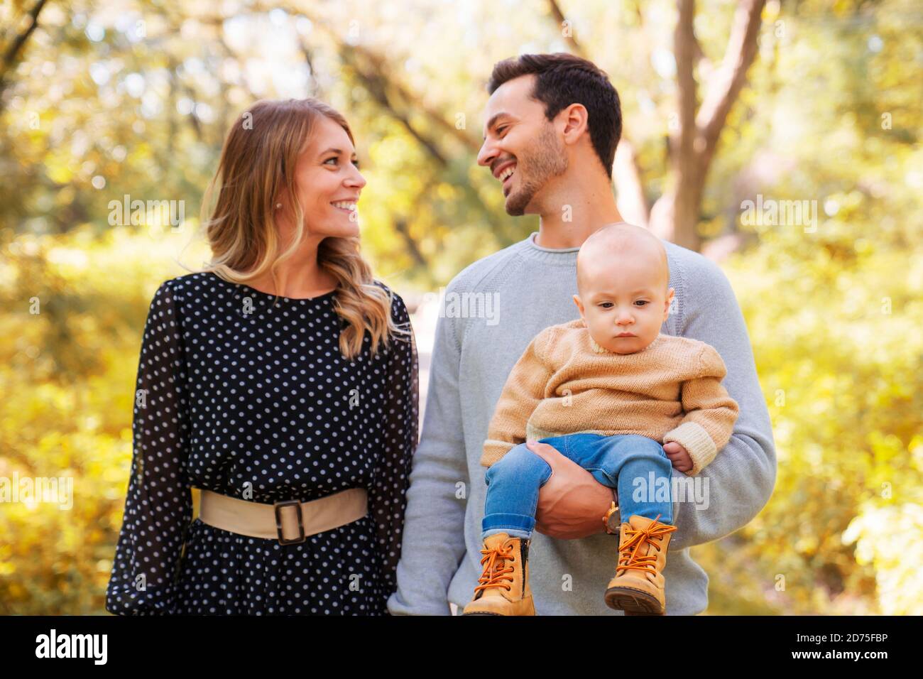 Family with a baby having fun in the forest Stock Photo - Alamy