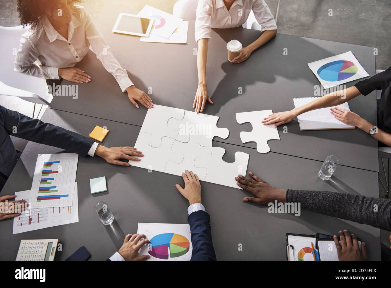 Teamwork of partners. Concept of integration and startup with puzzle ...