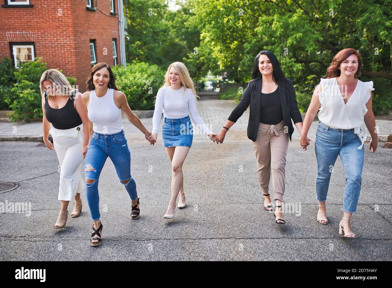 Group of girls friends walking outside together Stock Photo - Alamy