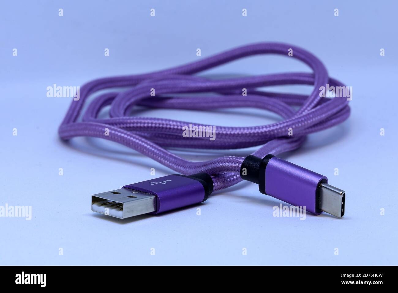 Closeup shot of a purple USB charging cable on a white surface Stock ...