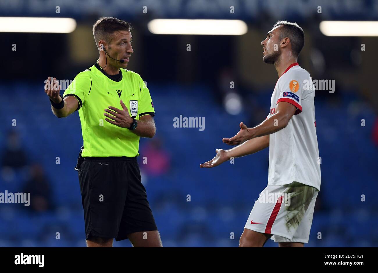 Referee Davide Massa with Sevilla's Joan Jordan during the Champions ...