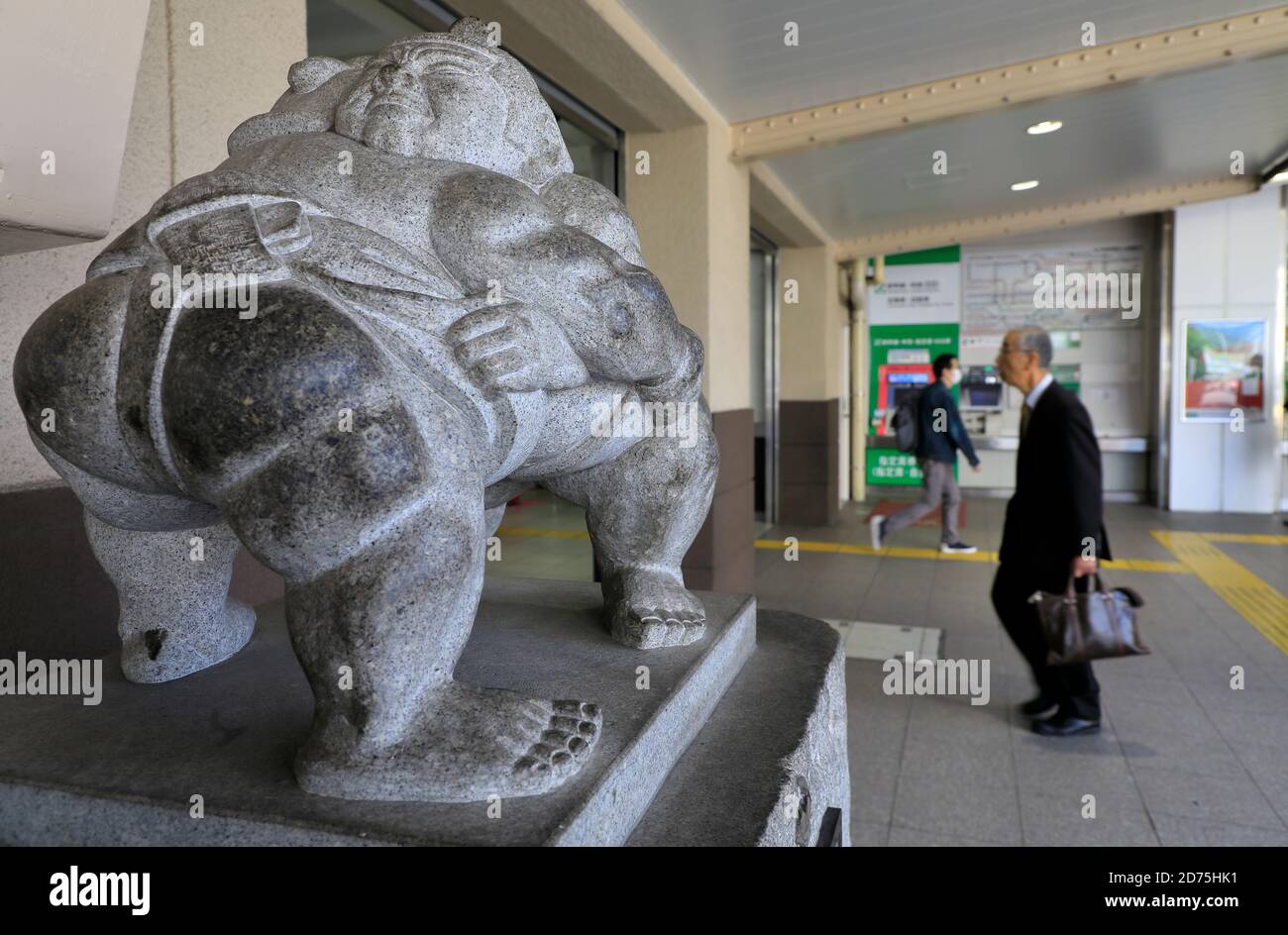 Stone carved Sumo Wrestling statue decorated the entrance of JR East ...