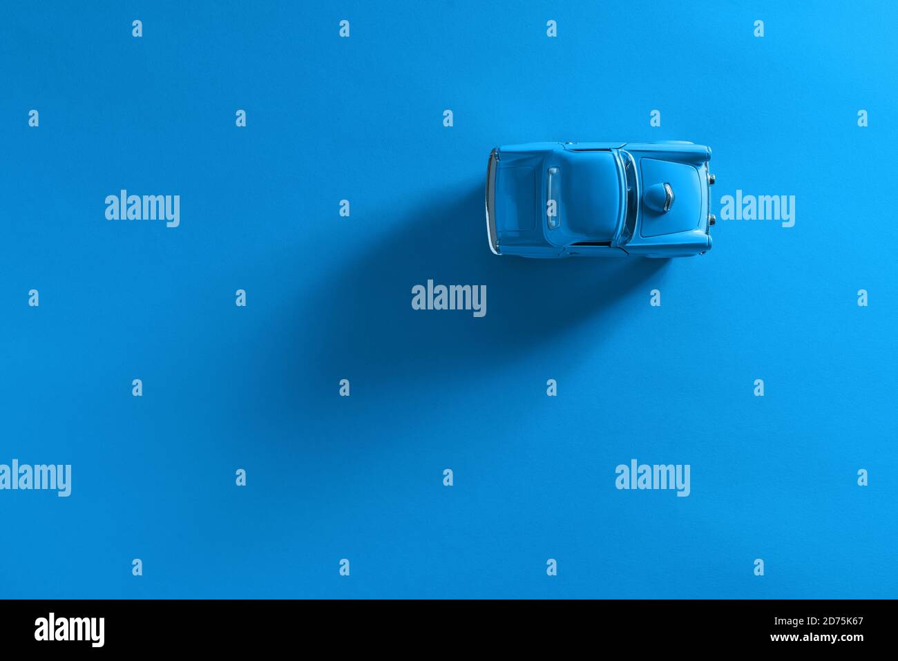 Top view of a Blue toy car on a blue background with long and side ...