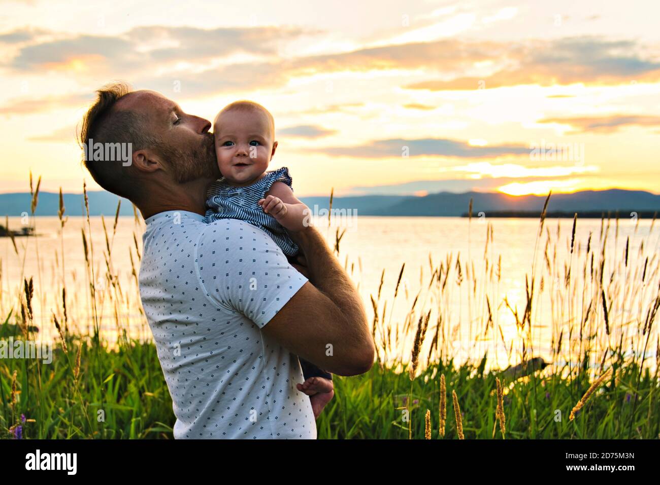 father and child girl at the sunset on the waterscape Stock Photo - Alamy