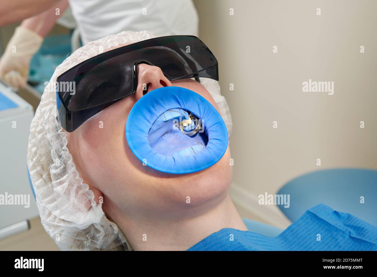 Patient getting dental treatment at dentist office with dental rubber ...