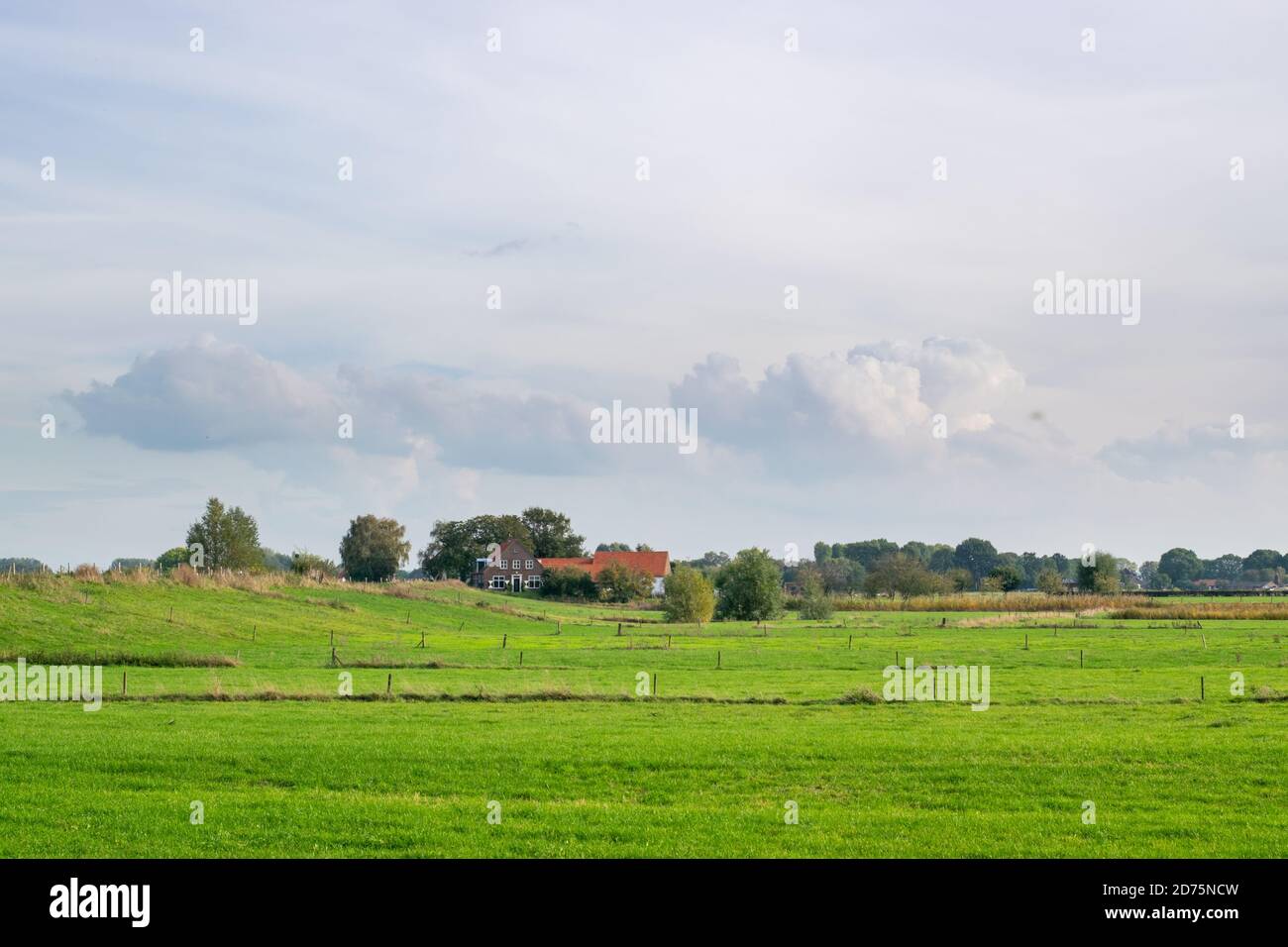 Old farm house standing alone in the Dutch polder landscape next to a ...