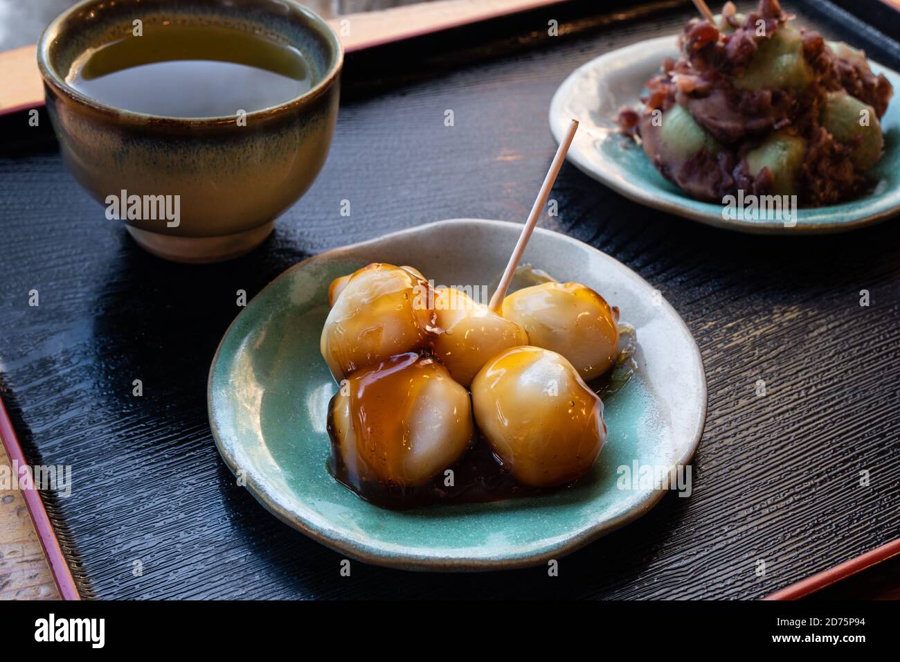 Dango, a type of Japanese sweet rice dumpling, next to green tea Stock ...