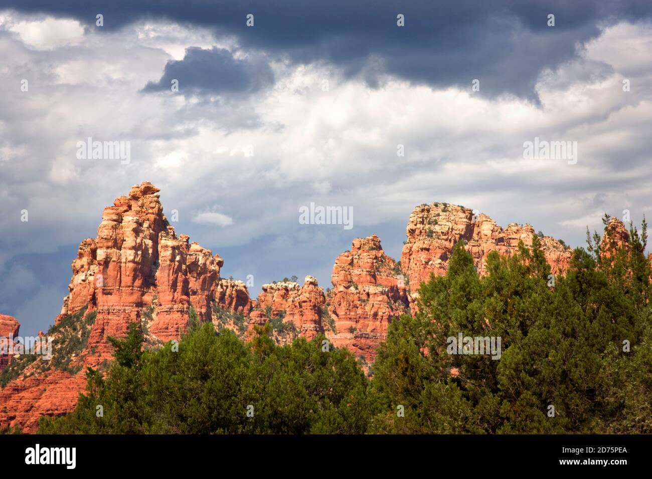 Afternoon thunderstorm clouds gather above red rock formations near ...