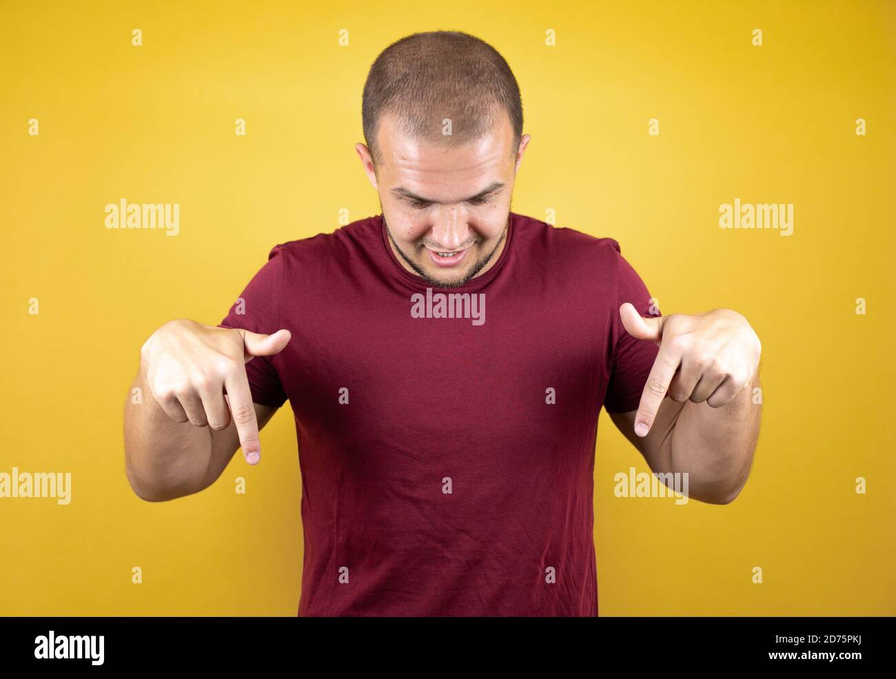 Russian man wearing basic red t-shirt over yellow insolated background ...