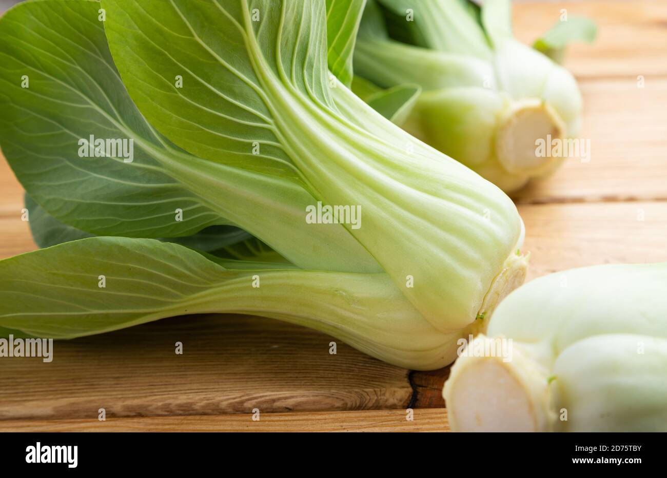 Fresh green bok choy or pac choi chinese cabbage on a brown wooden ...