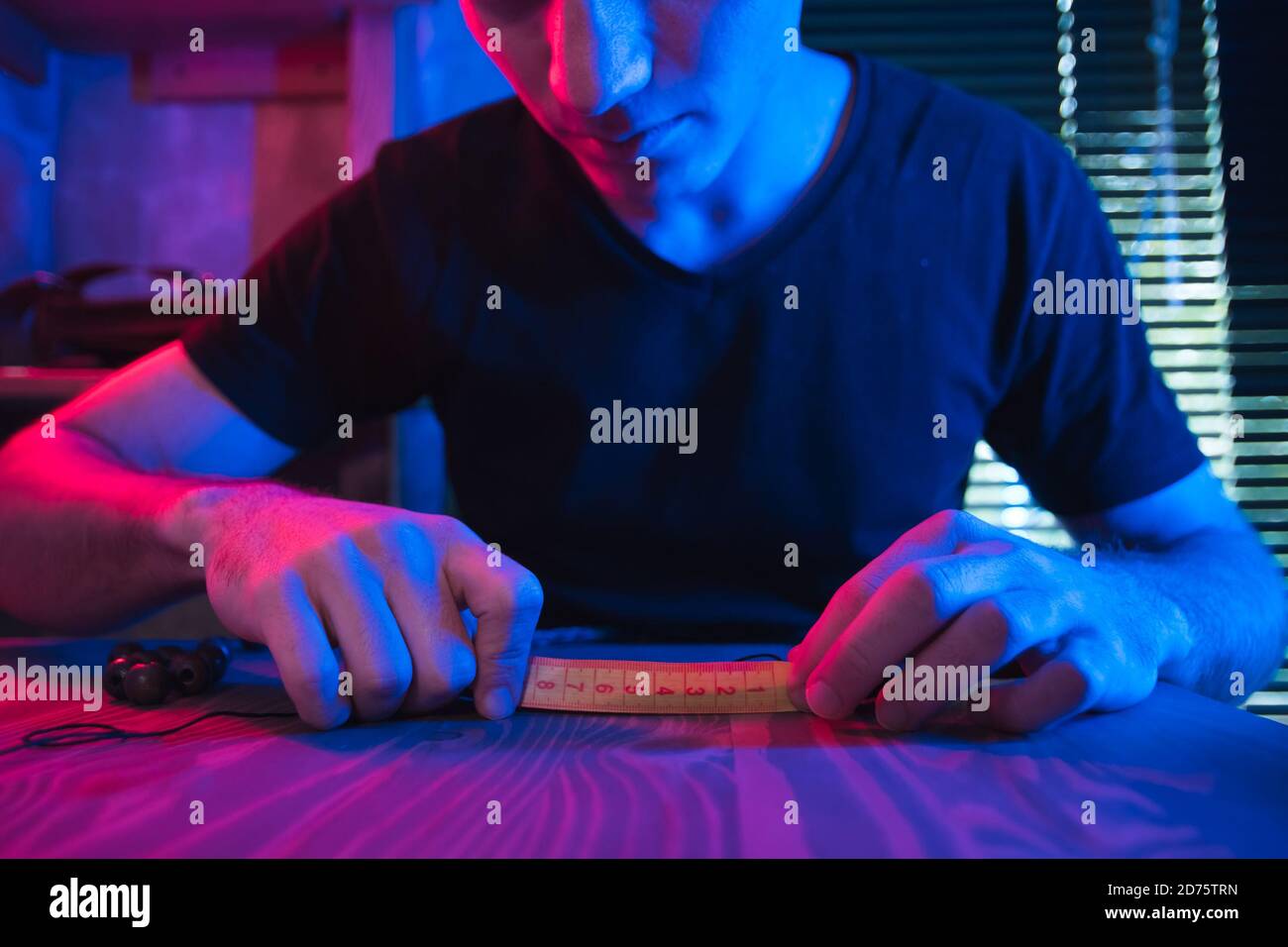 Dreamcatcher creation. Young man making dream hunter ind dark workshop ...