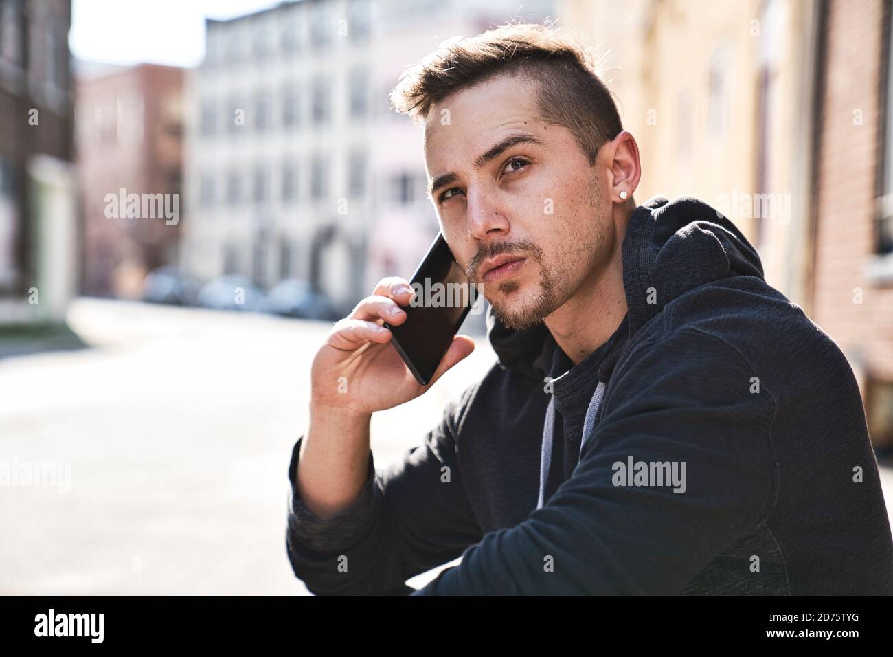 portrait of handsome male holding mobile phone Stock Photo - Alamy