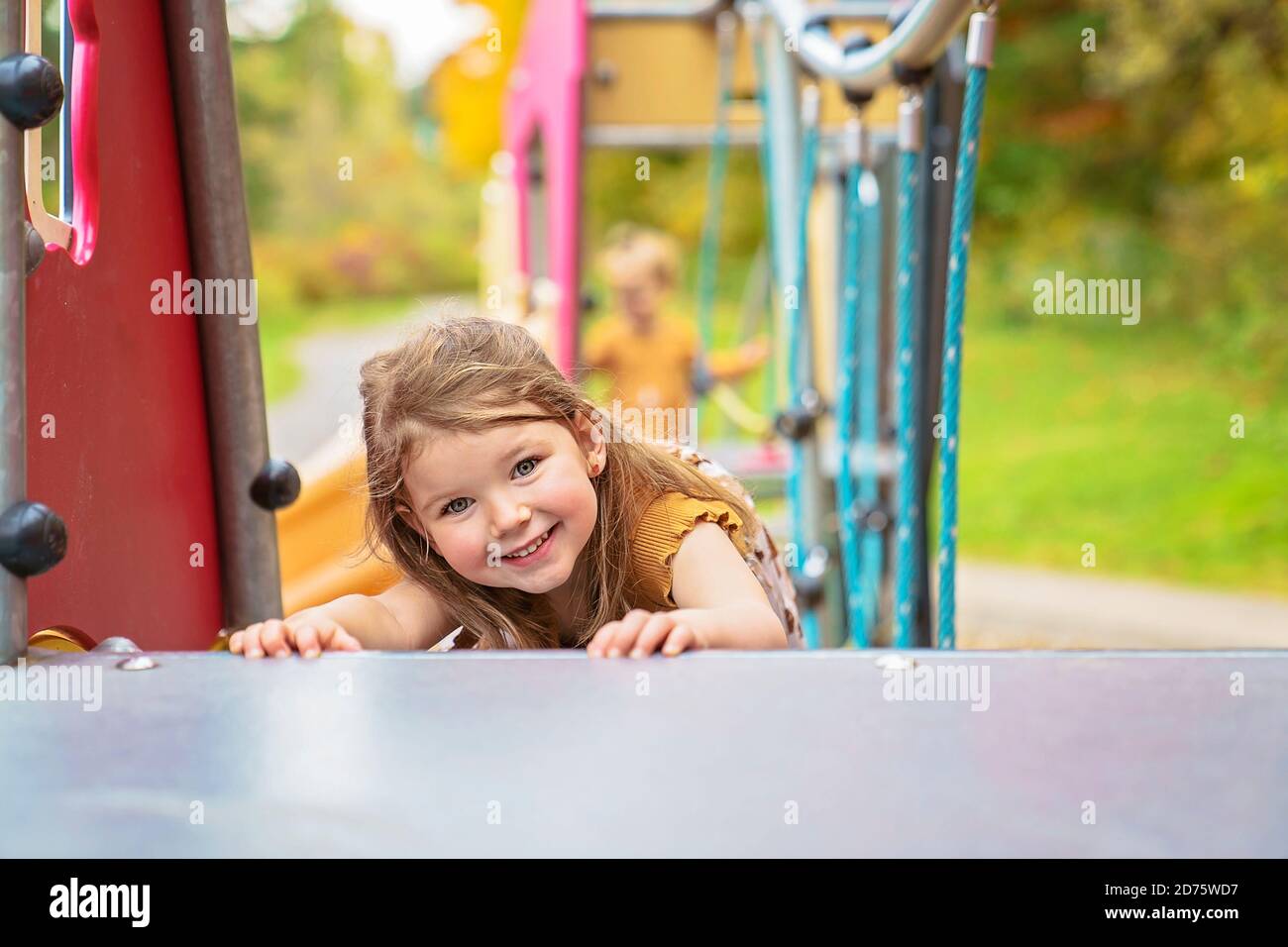 Happy Smiling Child Girl Playing At Playground Outdoors In a nice Park ...