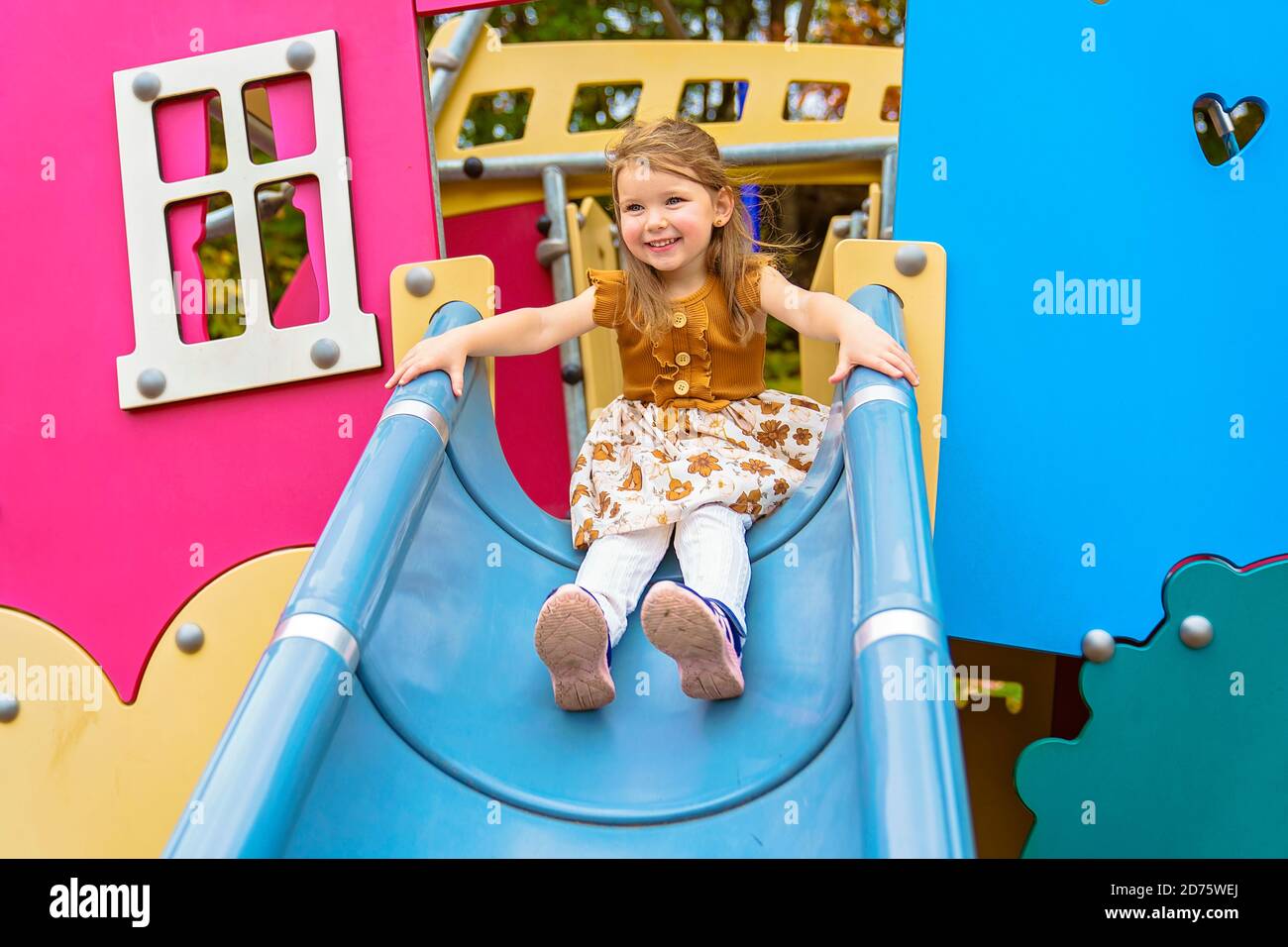 Happy Smiling Child Girl Playing At Playground Outdoors In a nice Park ...