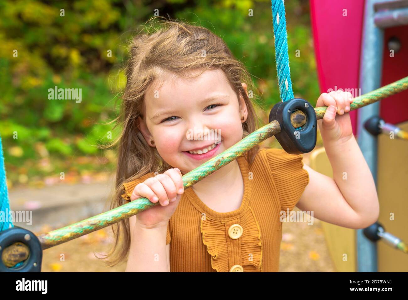 Happy Smiling Child Girl Playing At Playground Outdoors In a nice Park ...