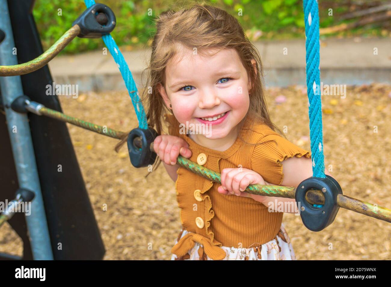 Happy Smiling Child Girl Playing At Playground Outdoors In a nice Park ...