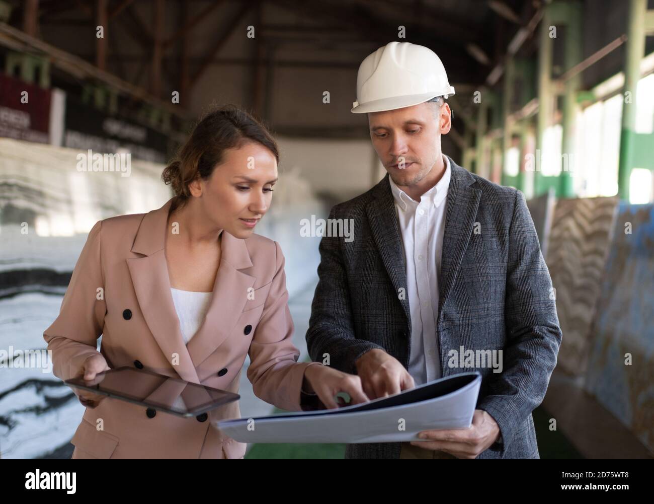 Contemporary busy managers of new warehouse project discussing ...